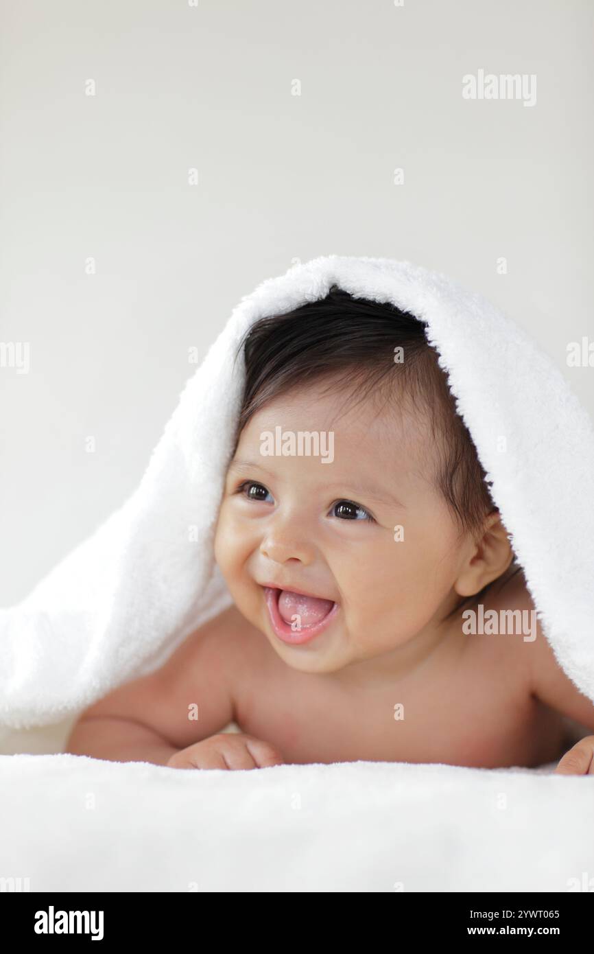 Baby with towel over head Stock Photo - Alamy