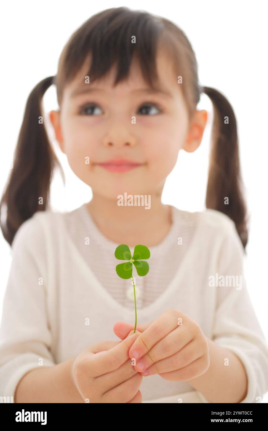 Girl with four-leaf clover Stock Photo - Alamy