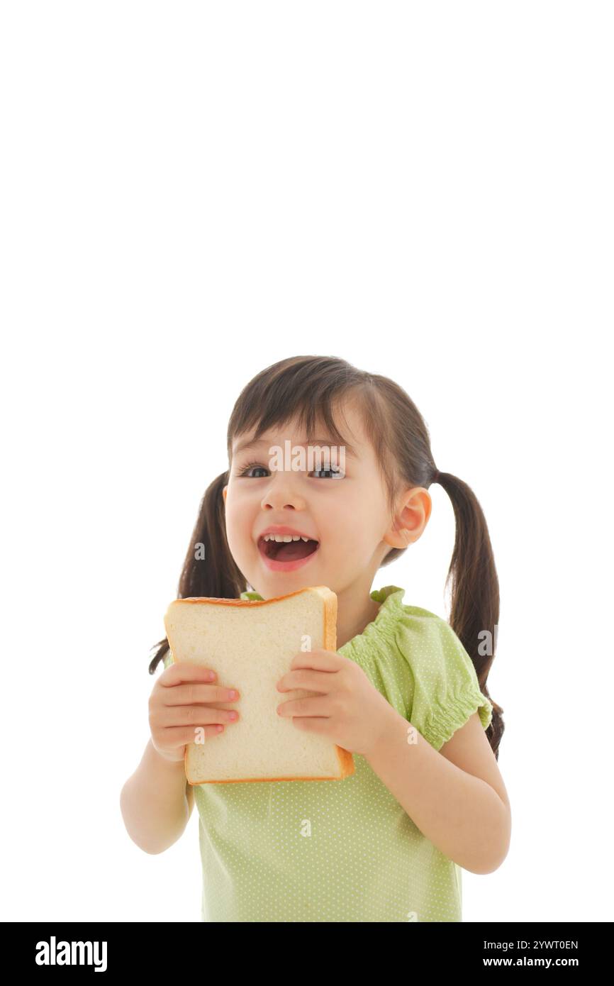 Girl eating a loaf of bread Stock Photo - Alamy