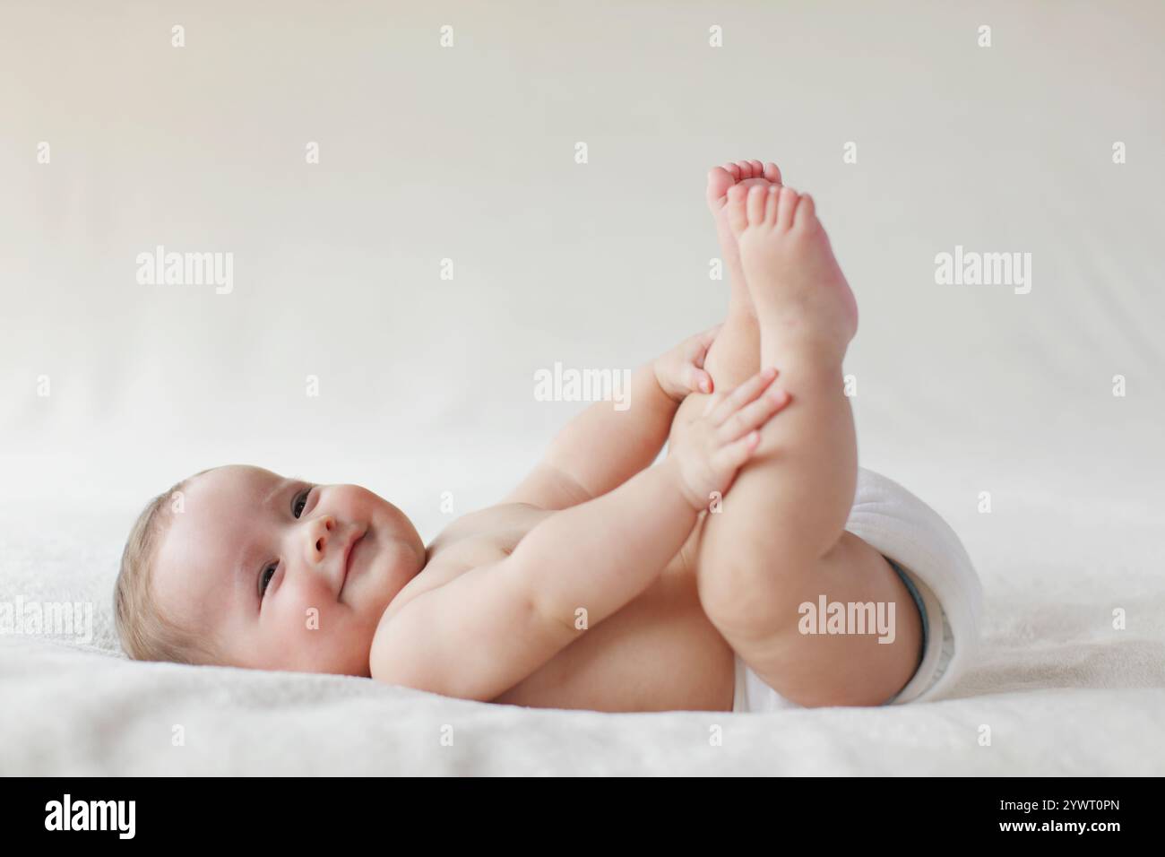 Foreign baby lying in bed Stock Photo - Alamy