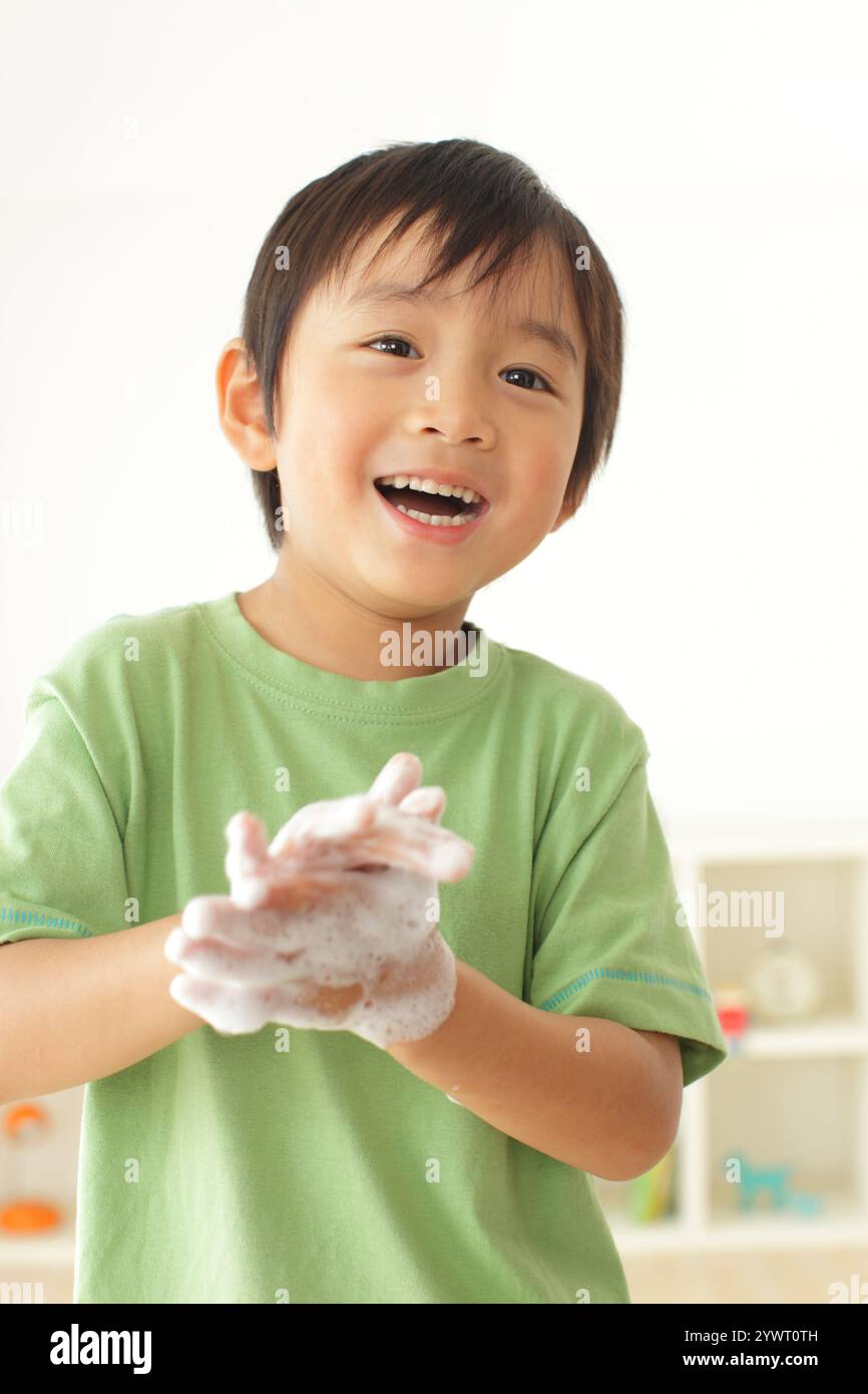 Boy washing hands with hand soap Stock Photo - Alamy
