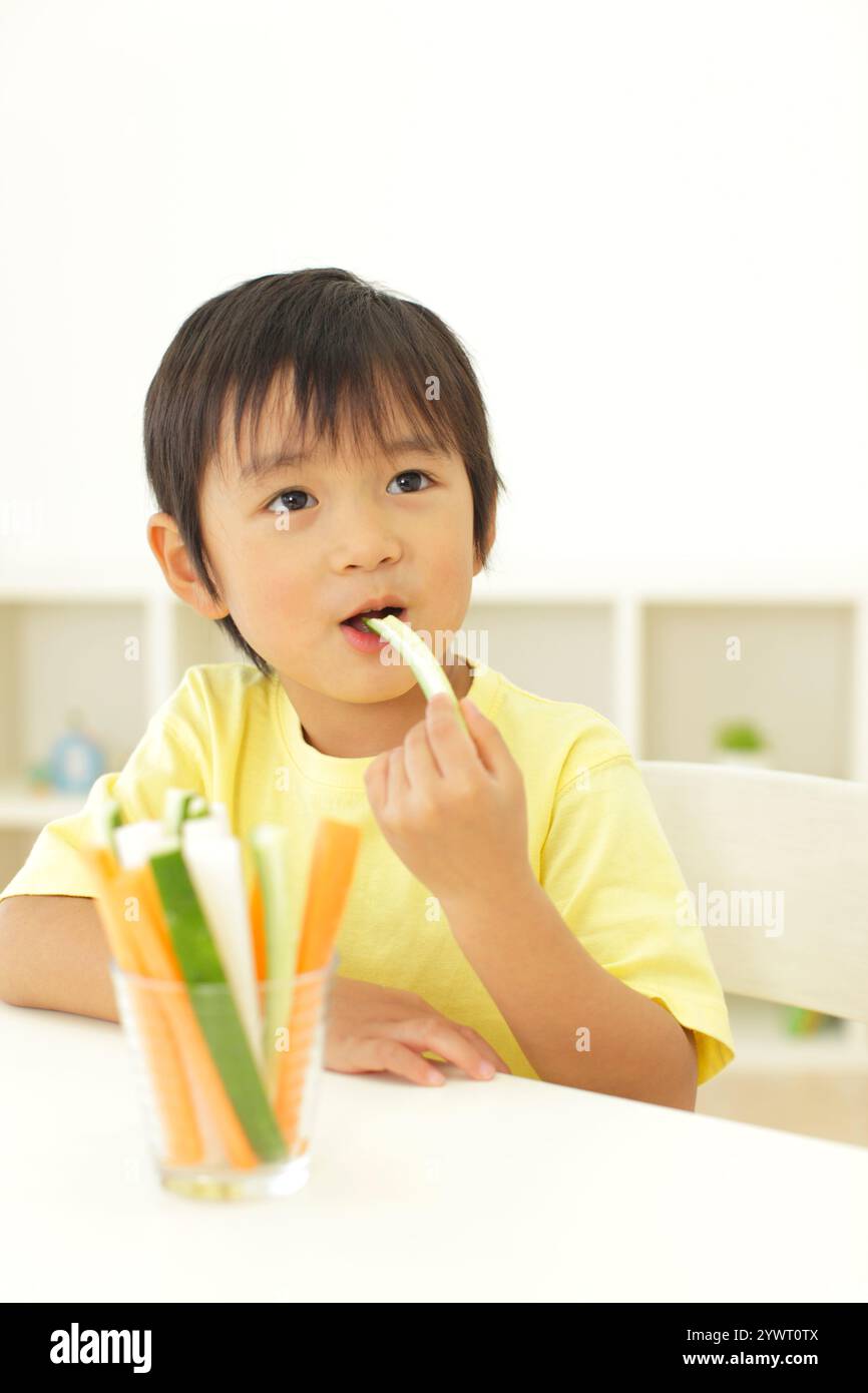 Boy eating vegetables Stock Photo - Alamy