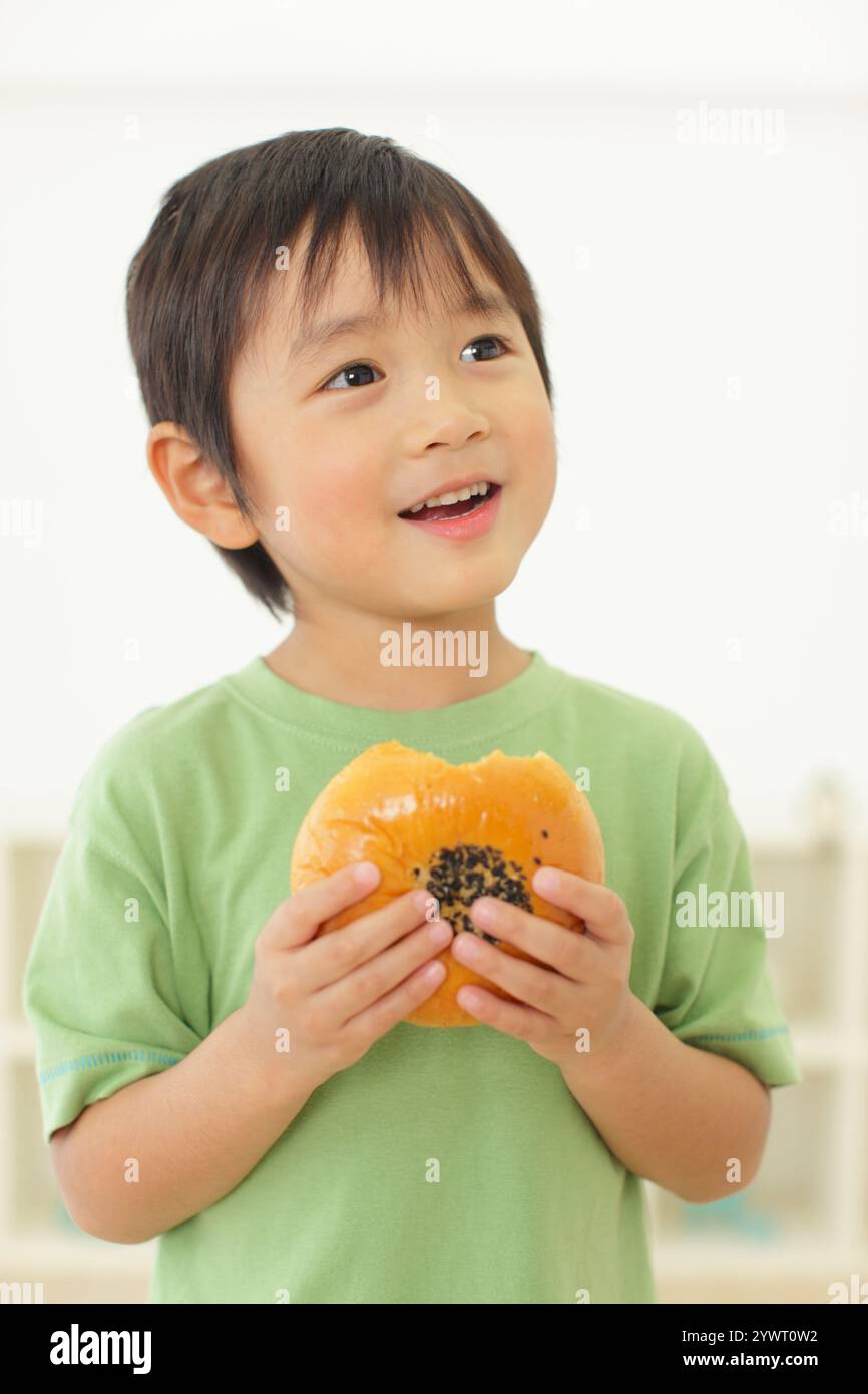 Boy eating bread Stock Photo - Alamy
