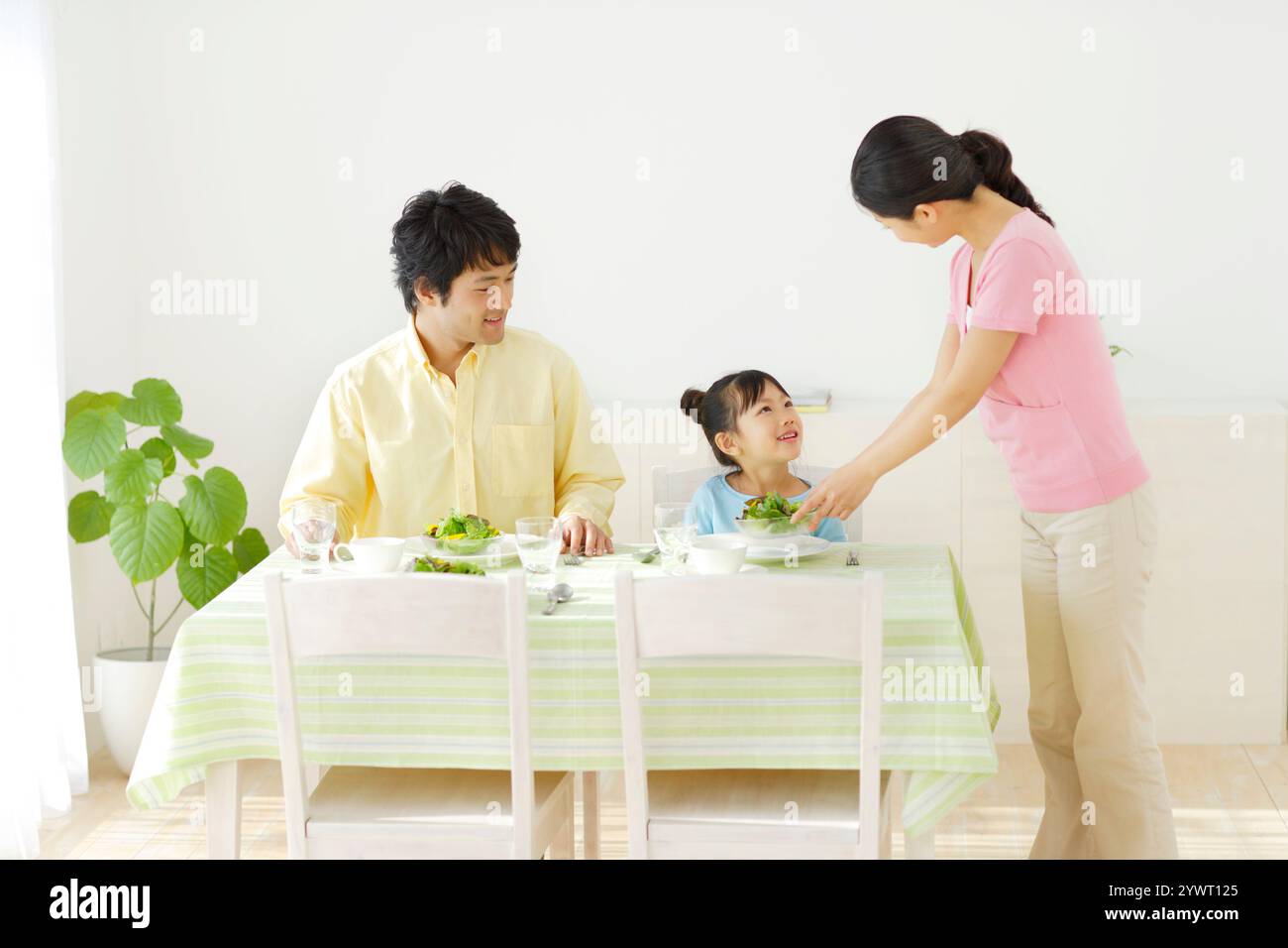 Family eating at dining table Stock Photo - Alamy