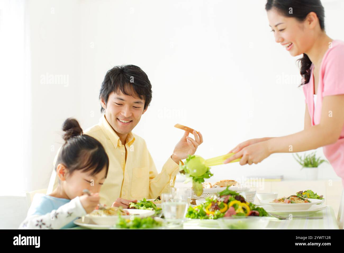 Family eating at dining table Stock Photo - Alamy