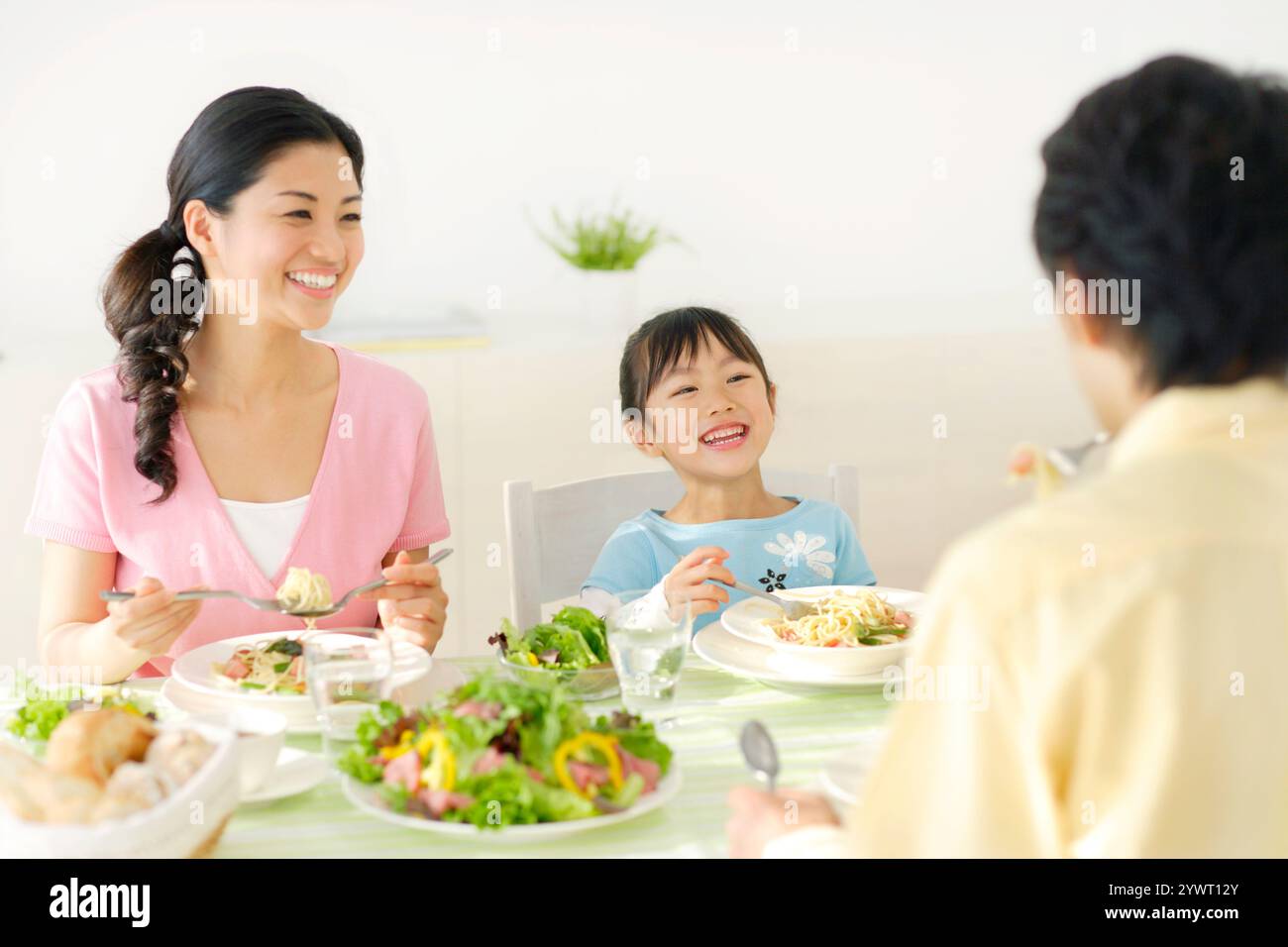 Family eating at dining table Stock Photo - Alamy