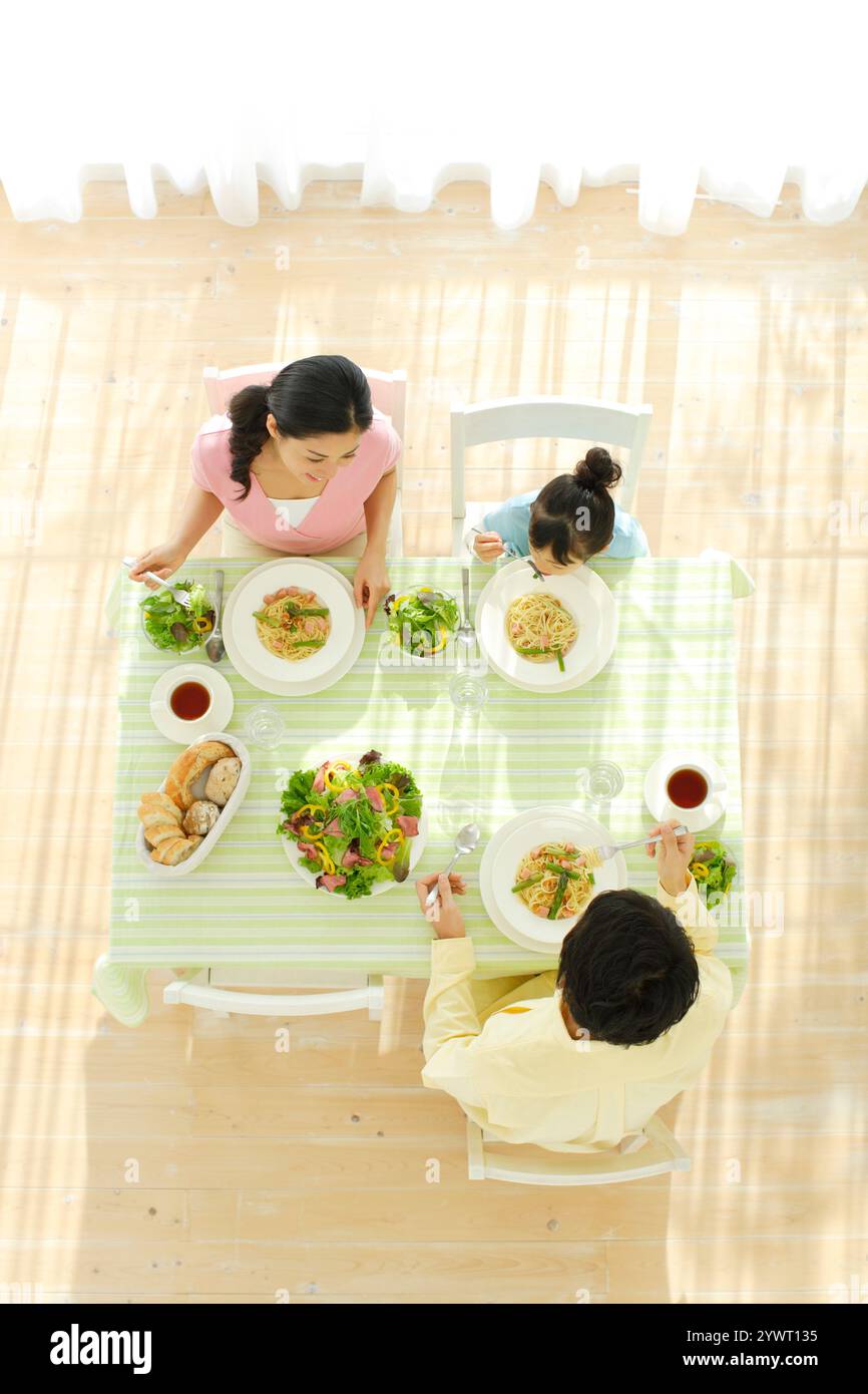 Overhead view of family eating at dining table Stock Photo - Alamy
