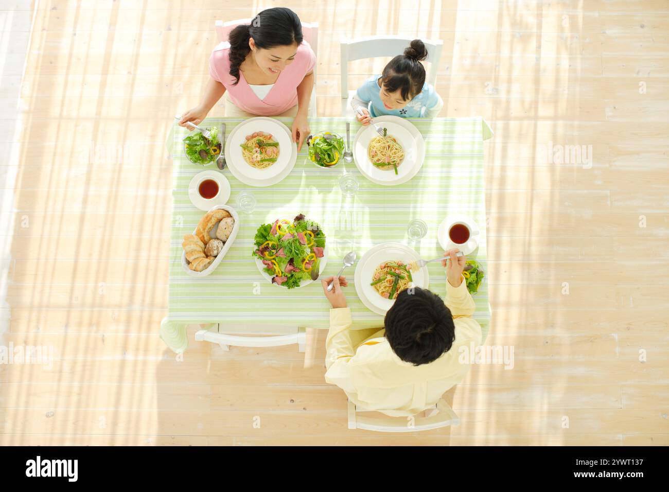 Overhead view of family eating at dining table Stock Photo - Alamy