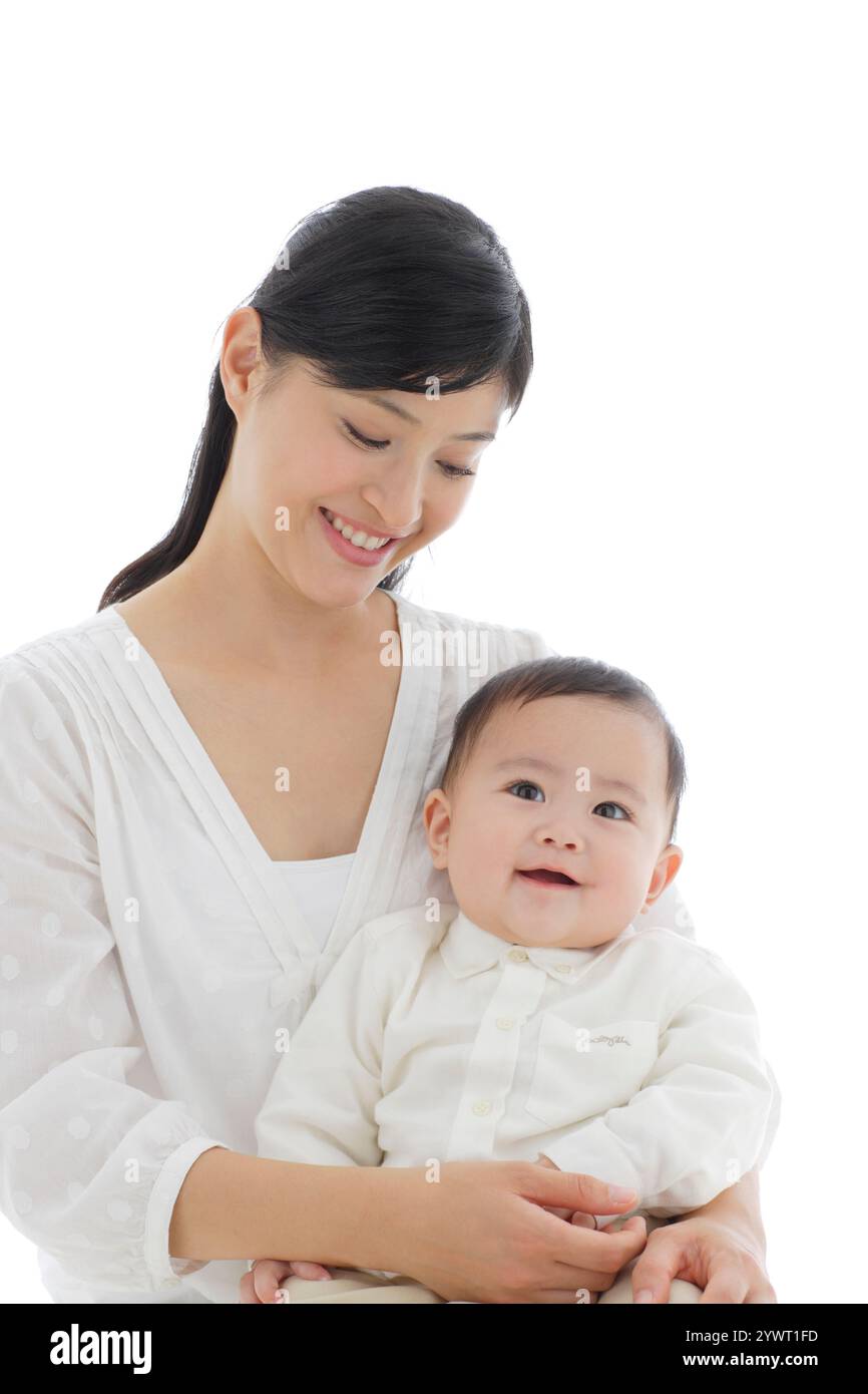 Baby being carried by mother Stock Photo - Alamy