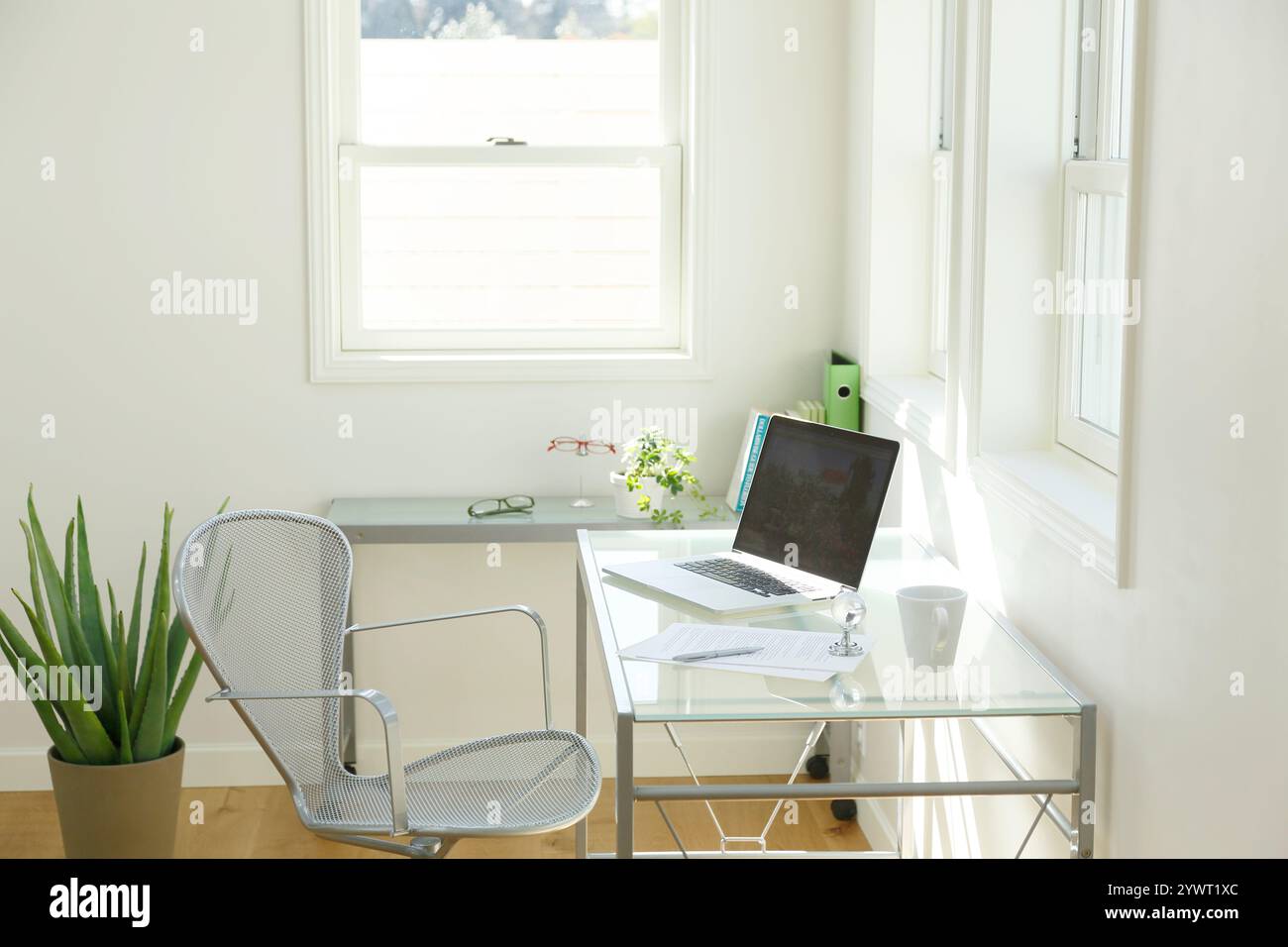 Bright living room with computer and desk Stock Photo - Alamy
