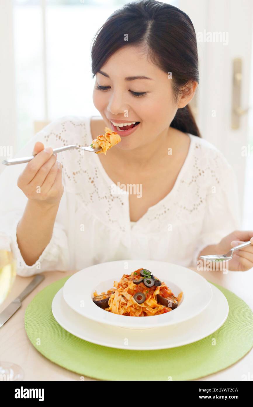 Black woman eating pasta hi-res stock photography and images - Alamy