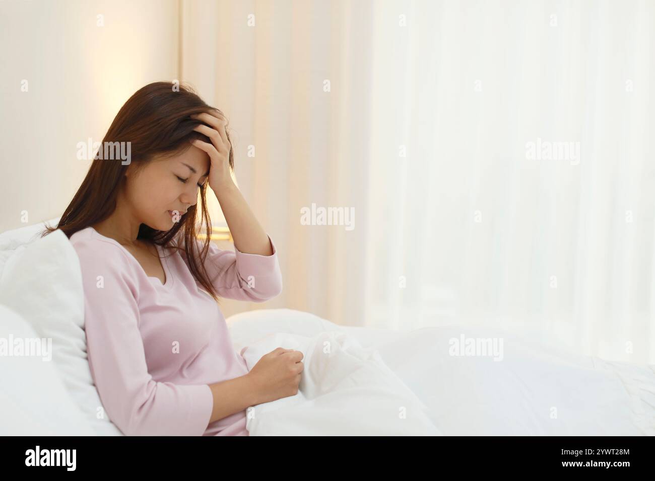 Woman pressing her head down due to headache Stock Photo - Alamy