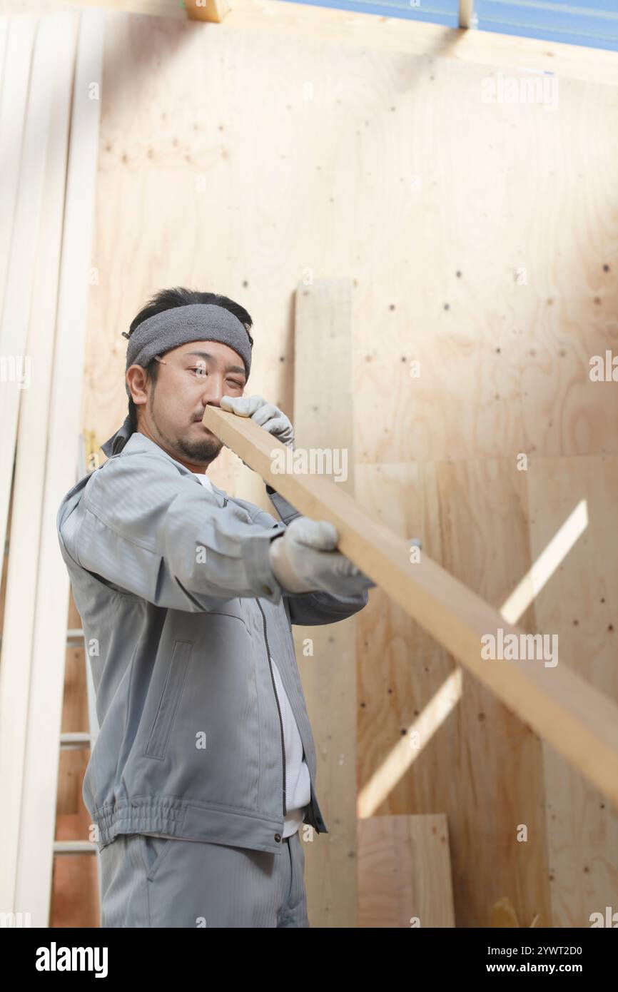 Carpenter man checking timber Stock Photo - Alamy
