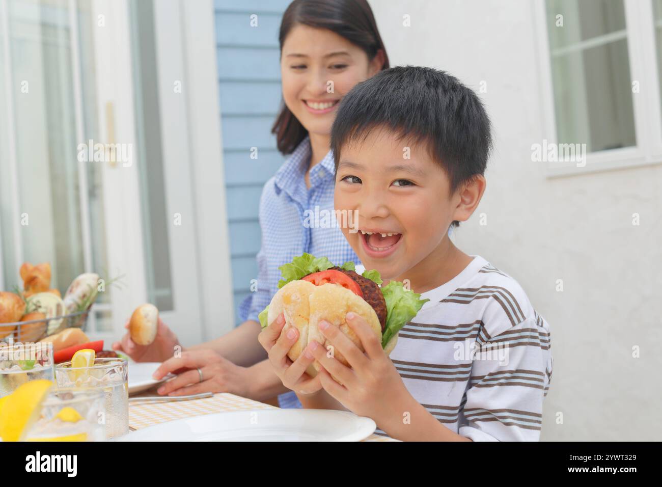 Boy eating hamburger Stock Photo - Alamy