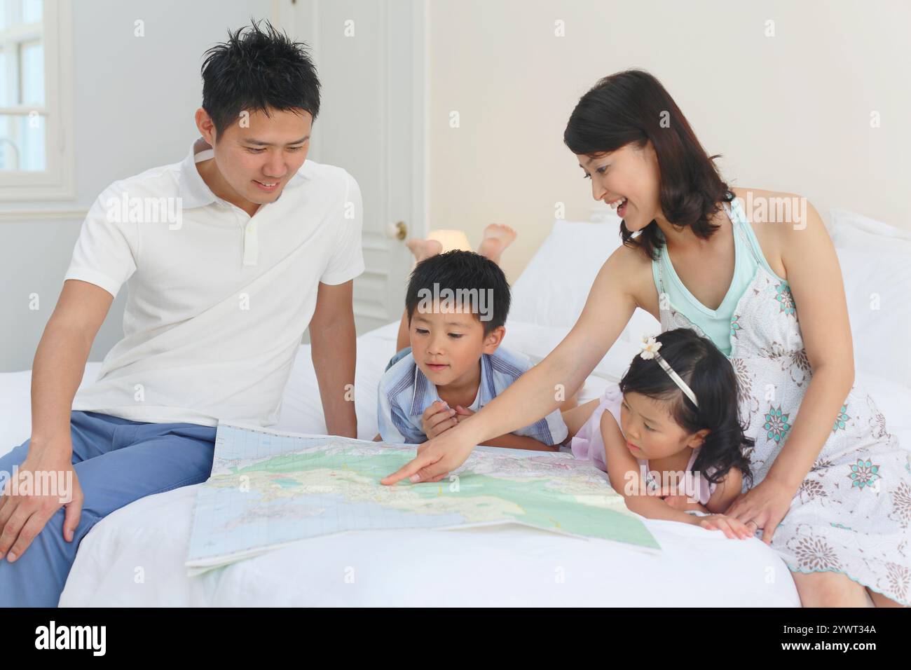 Family making travel plans while looking at map Stock Photo - Alamy