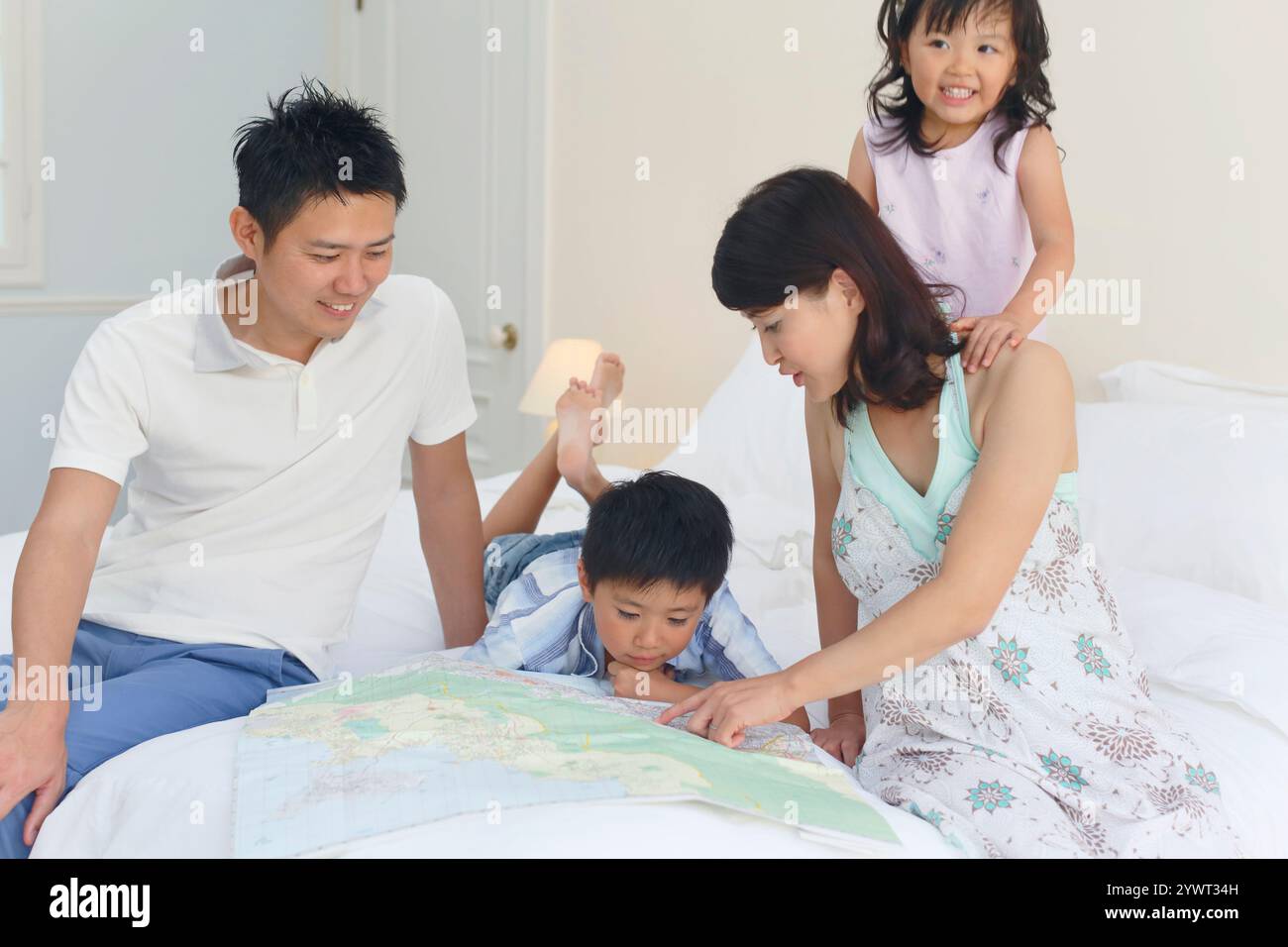 Family making travel plans while looking at map Stock Photo - Alamy