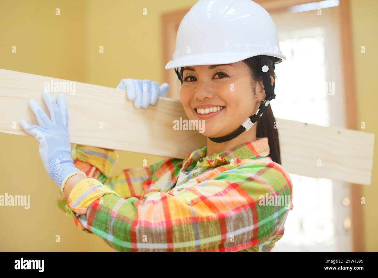 Woman working on construction site wearing helmet Stock Photo - Alamy