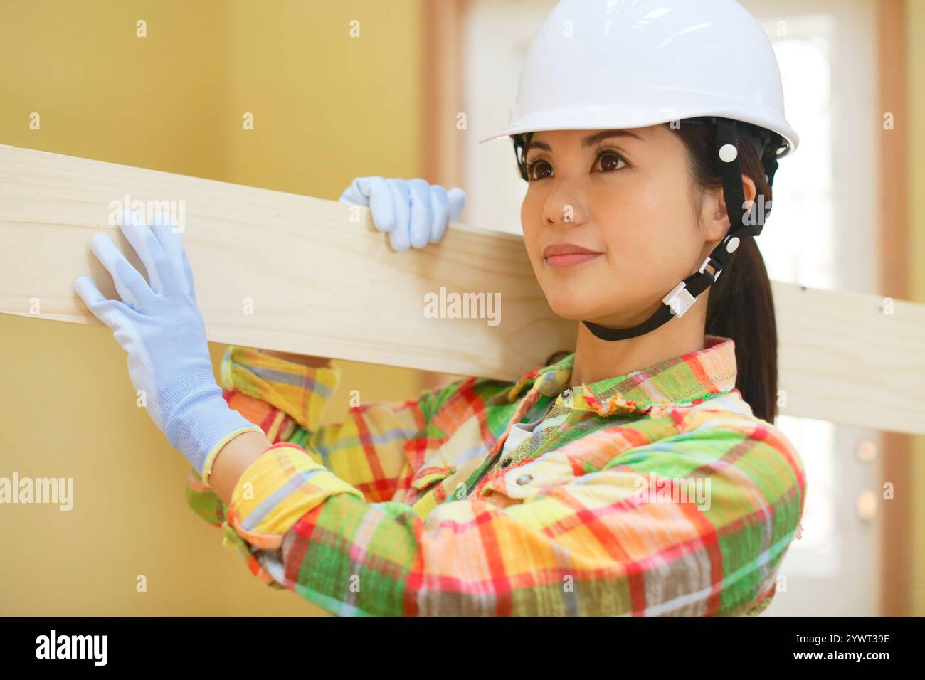 Woman working on construction site wearing helmet Stock Photo - Alamy