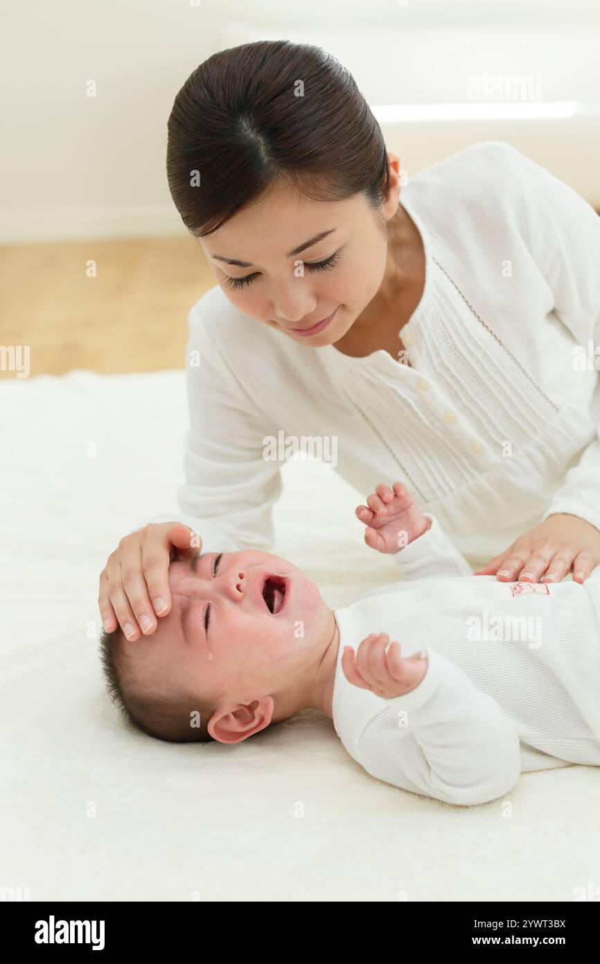 Baby who is unwell and mother nursing her baby Stock Photo - Alamy