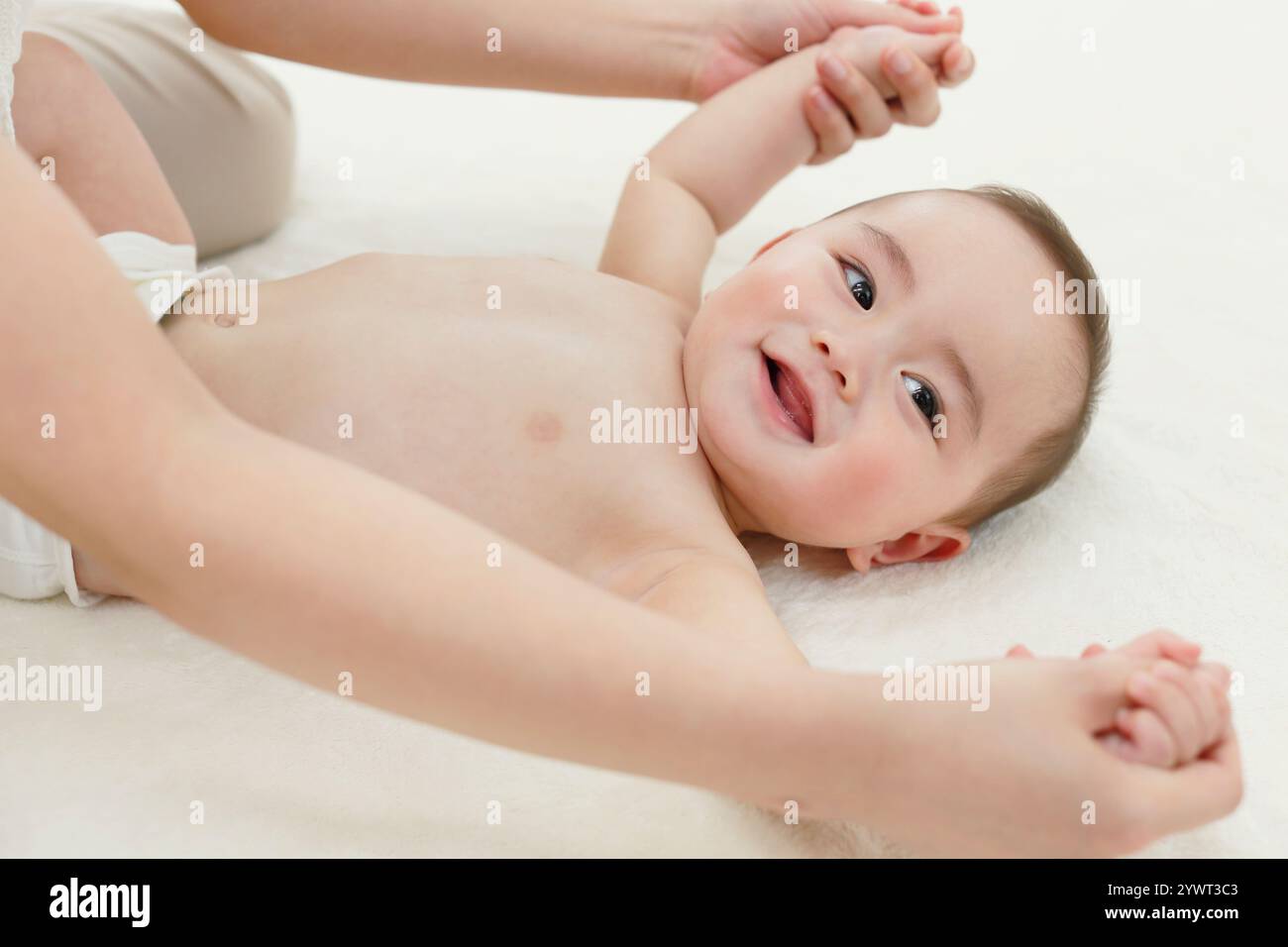 Mother and baby giving baby massage Stock Photo - Alamy
