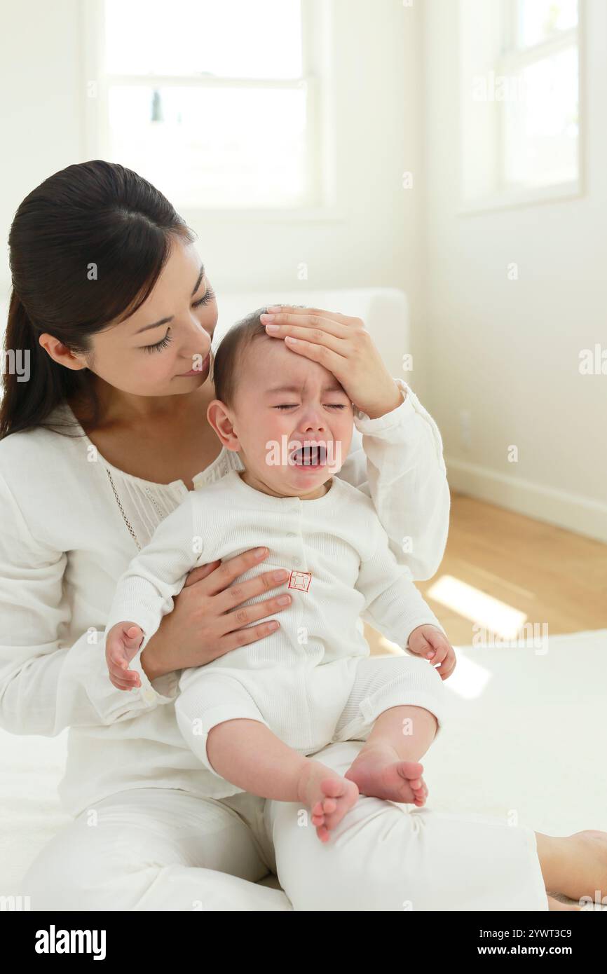 Baby who is unwell and mother nursing her baby Stock Photo - Alamy