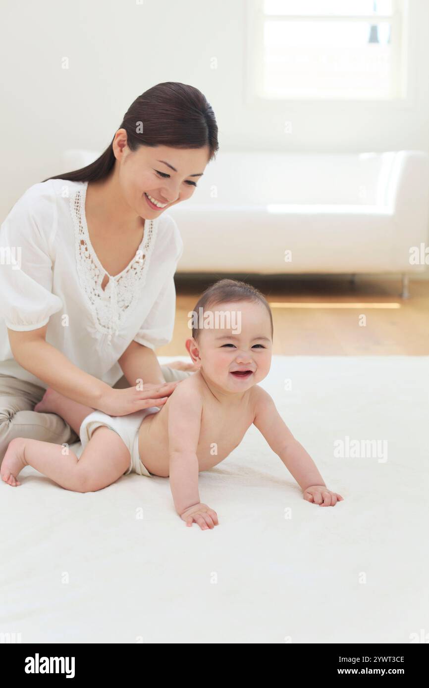 Mother and baby giving baby massage Stock Photo - Alamy