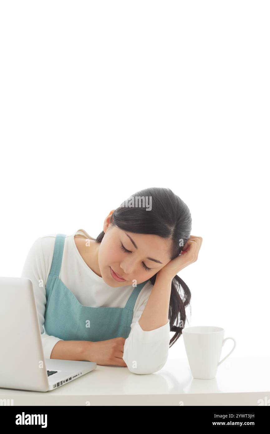 Woman closing her eyes tiredly while using a computer Stock Photo - Alamy