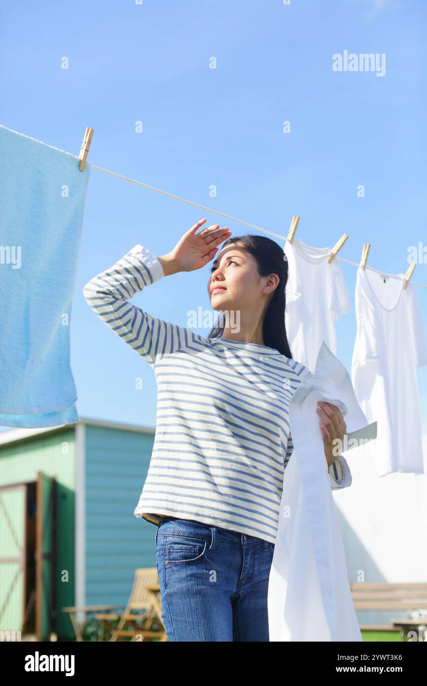 Housewife drying clothes in the glaring sun Stock Photo - Alamy