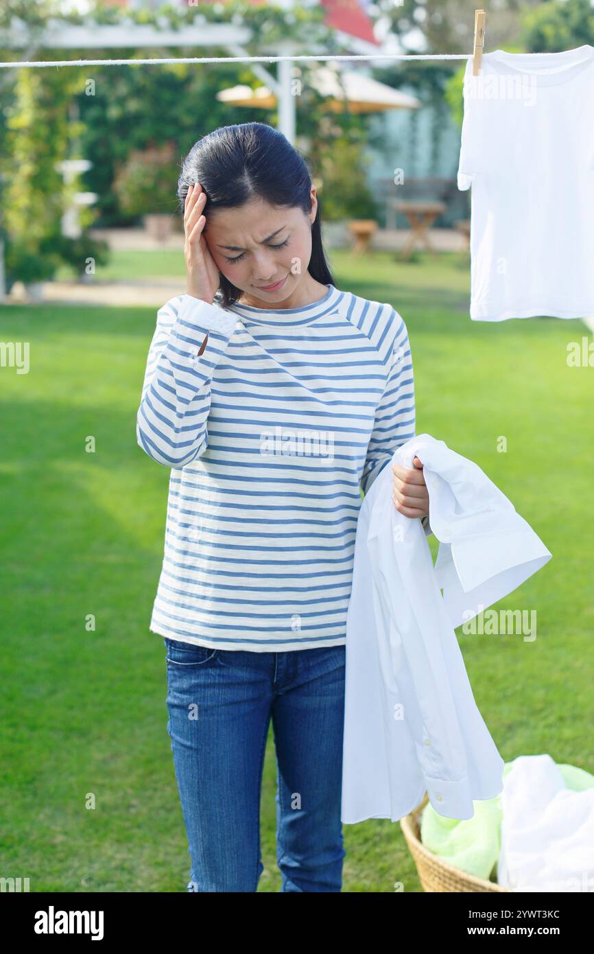 Housewife feeling sick while drying laundry Stock Photo - Alamy