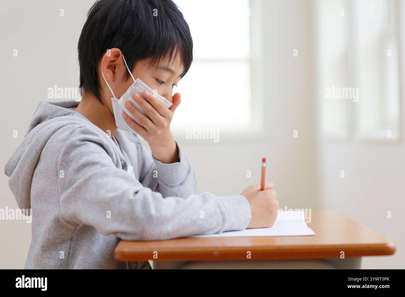 Primary school student coughing during class Stock Photo - Alamy