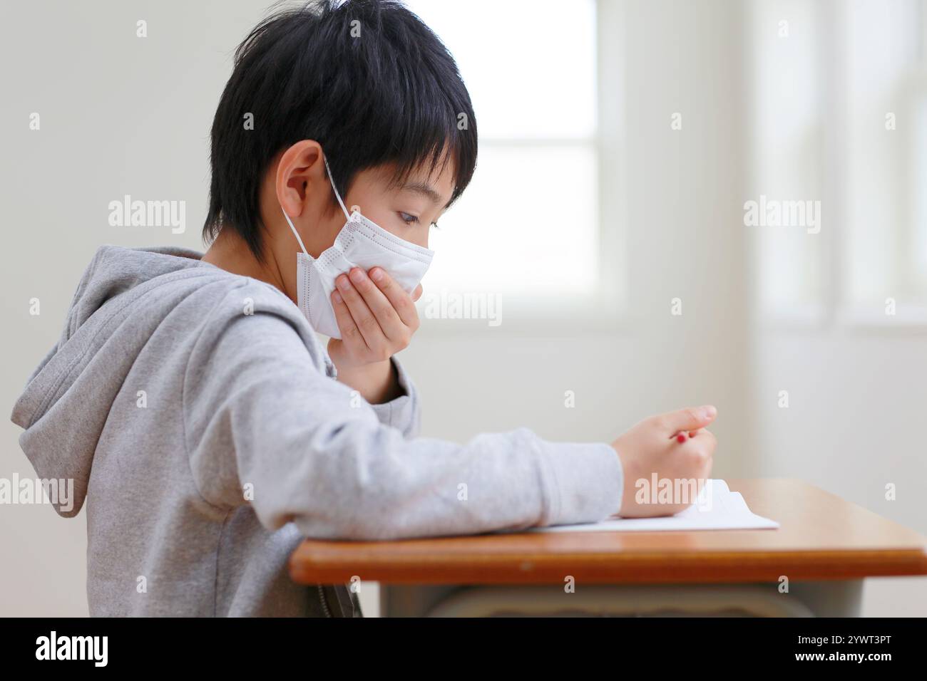 Primary school student coughing during class Stock Photo - Alamy