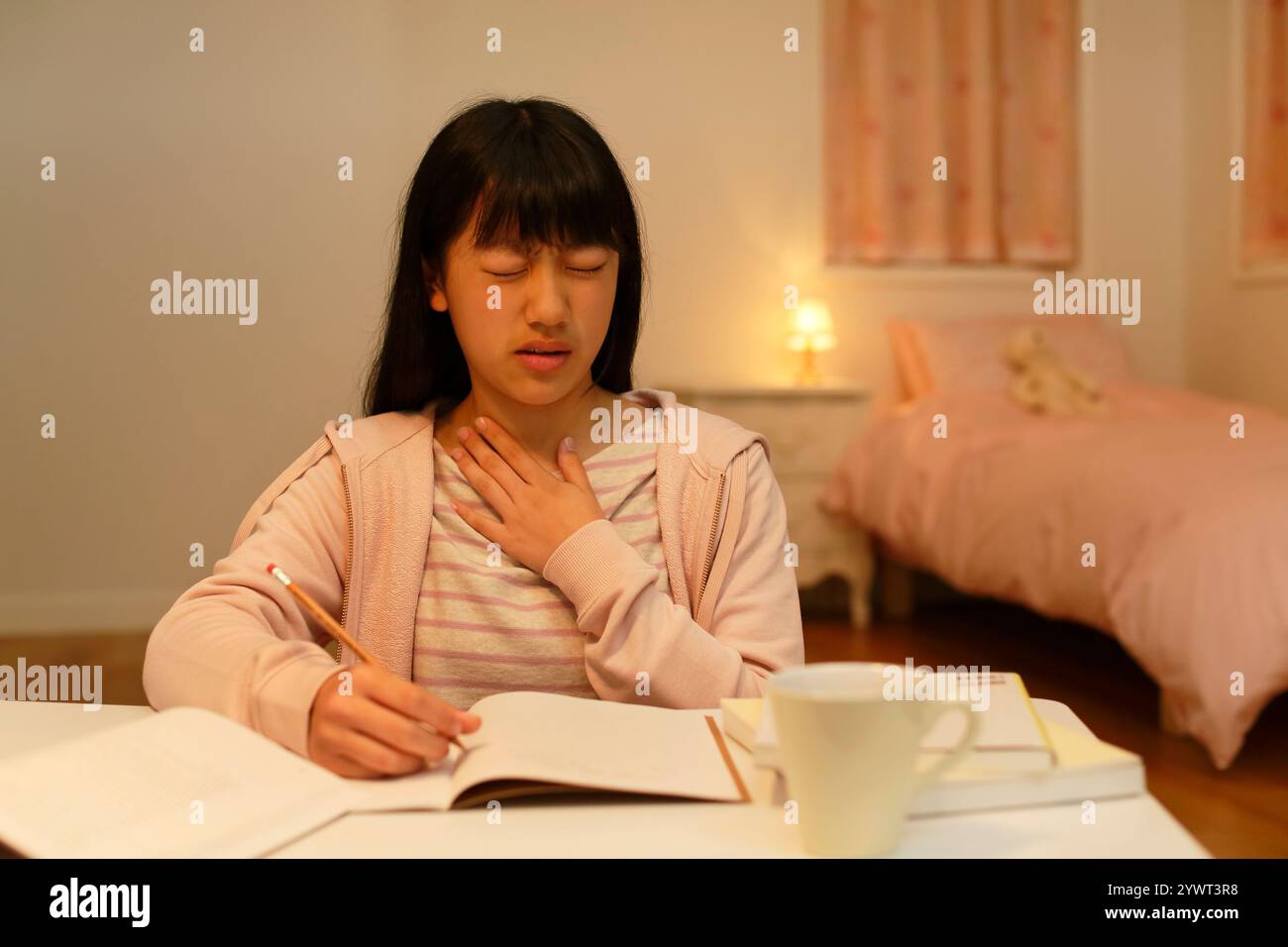 Girl getting sick while studying late at night Stock Photo - Alamy