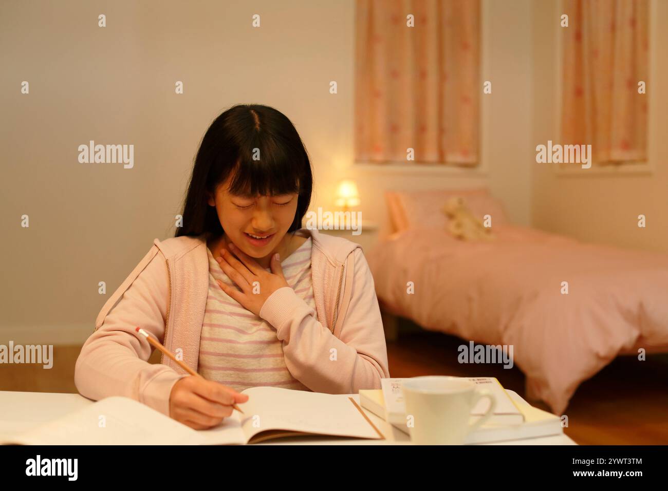 Girl getting sick while studying late at night Stock Photo - Alamy