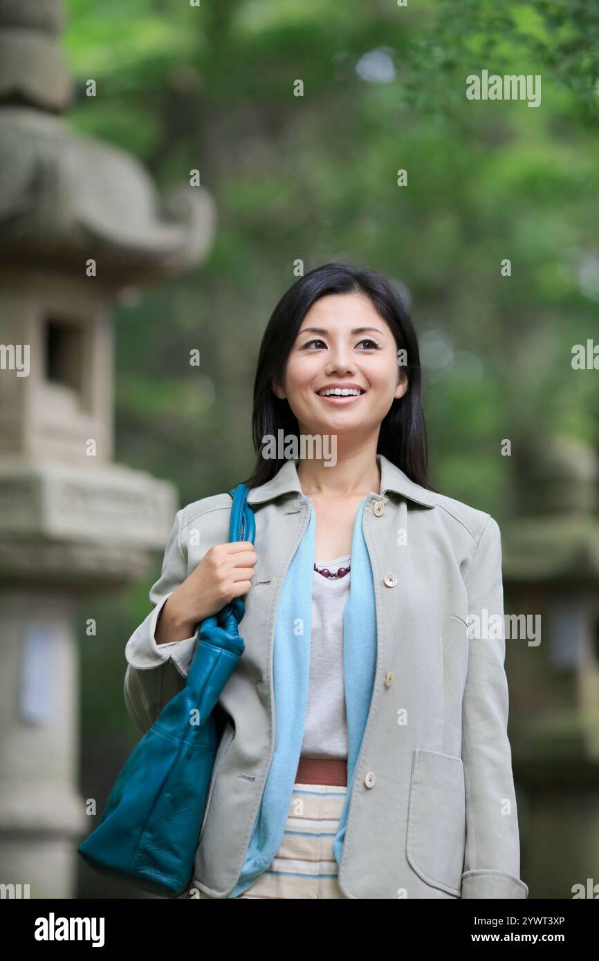 Young woman sightseeing at the temple Stock Photo - Alamy