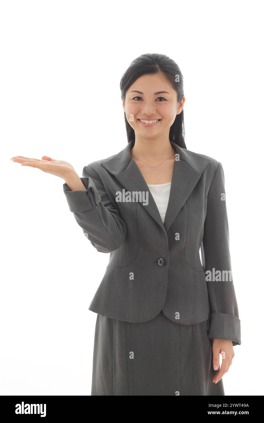 Businesswoman striking a guiding pose Stock Photo - Alamy