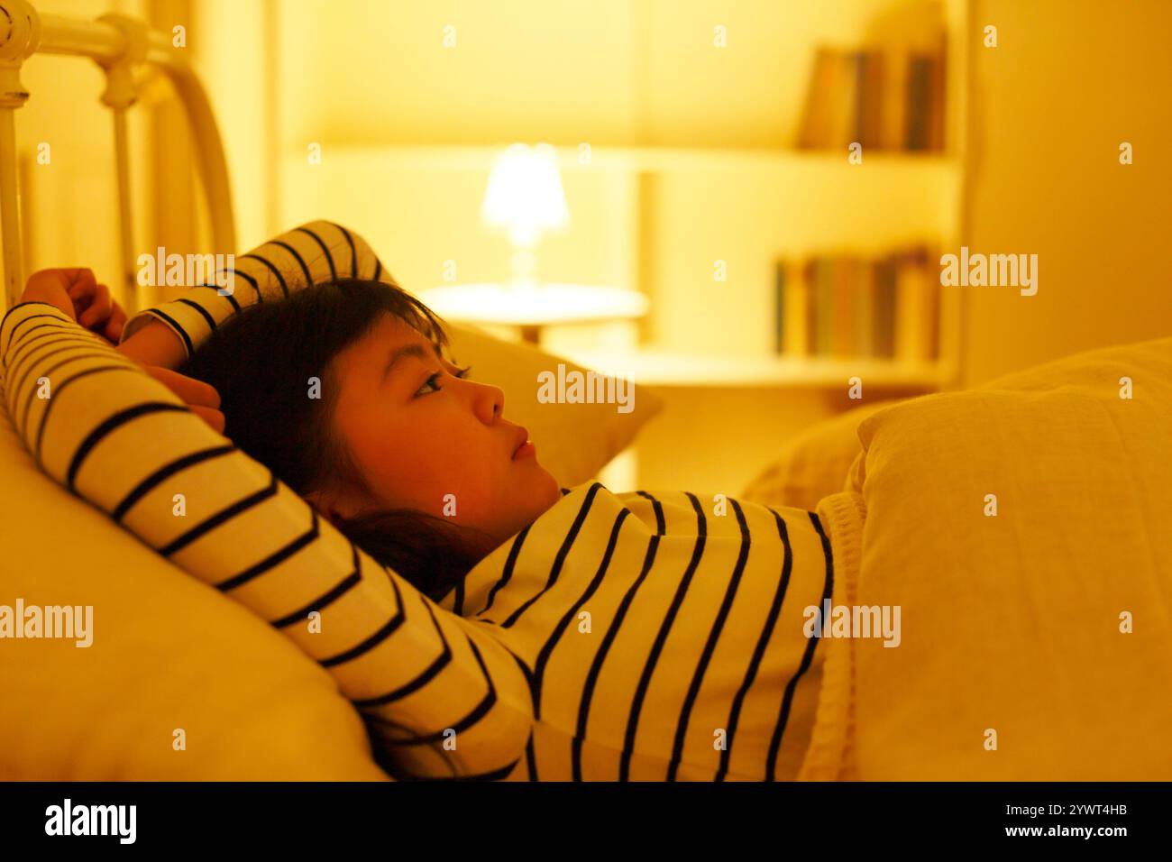 A girl who is not feeling well getting into her futon Stock Photo - Alamy