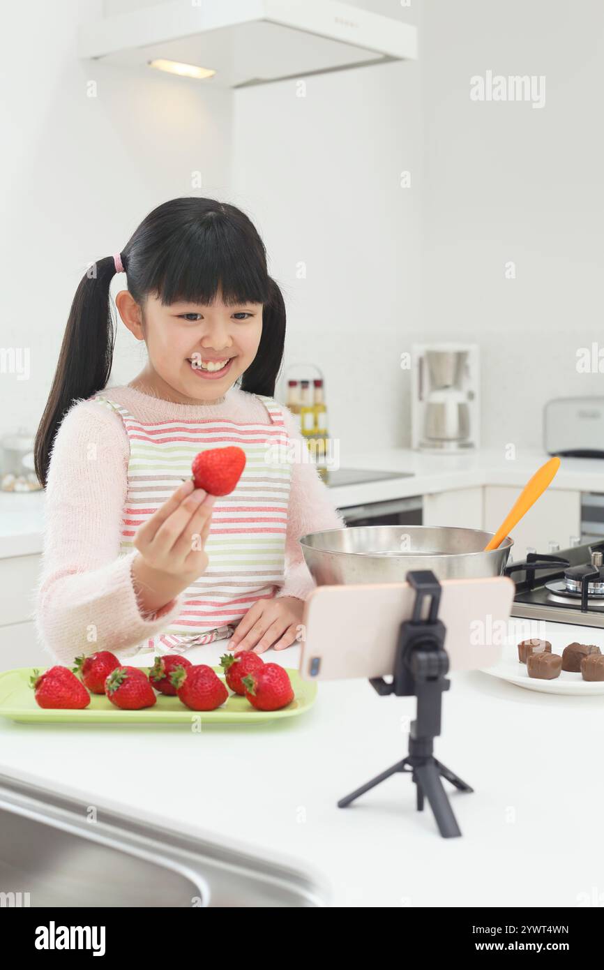 Small you-tubers explaining how to make sweets Stock Photo - Alamy