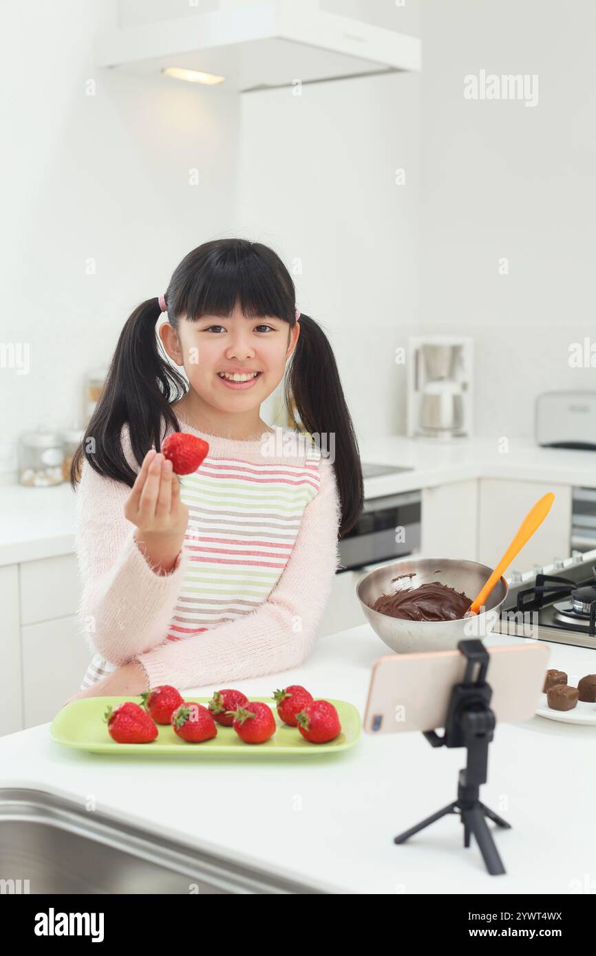 Small you-tubers explaining how to make sweets Stock Photo - Alamy