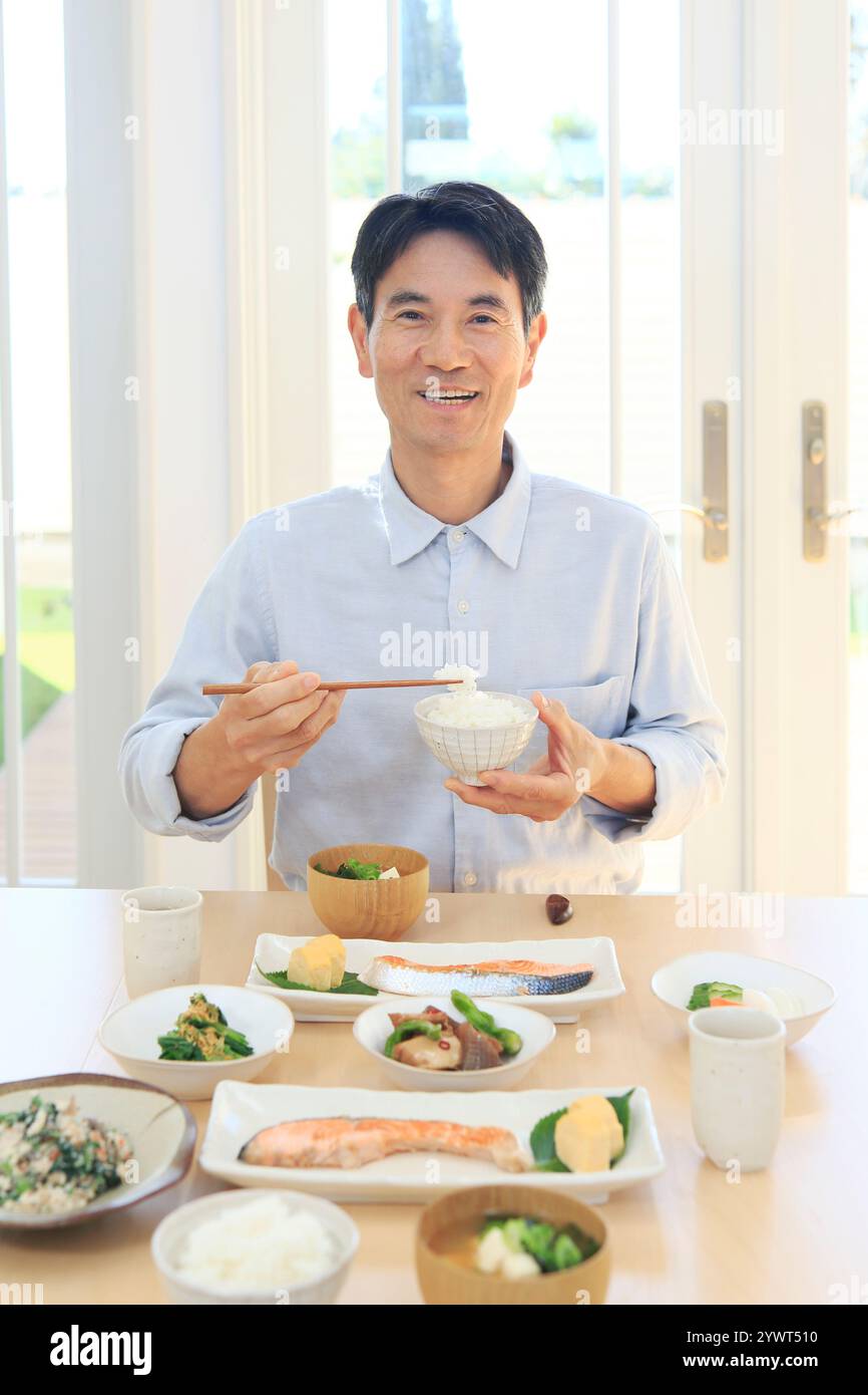 Middle-aged man eating breakfast Stock Photo - Alamy