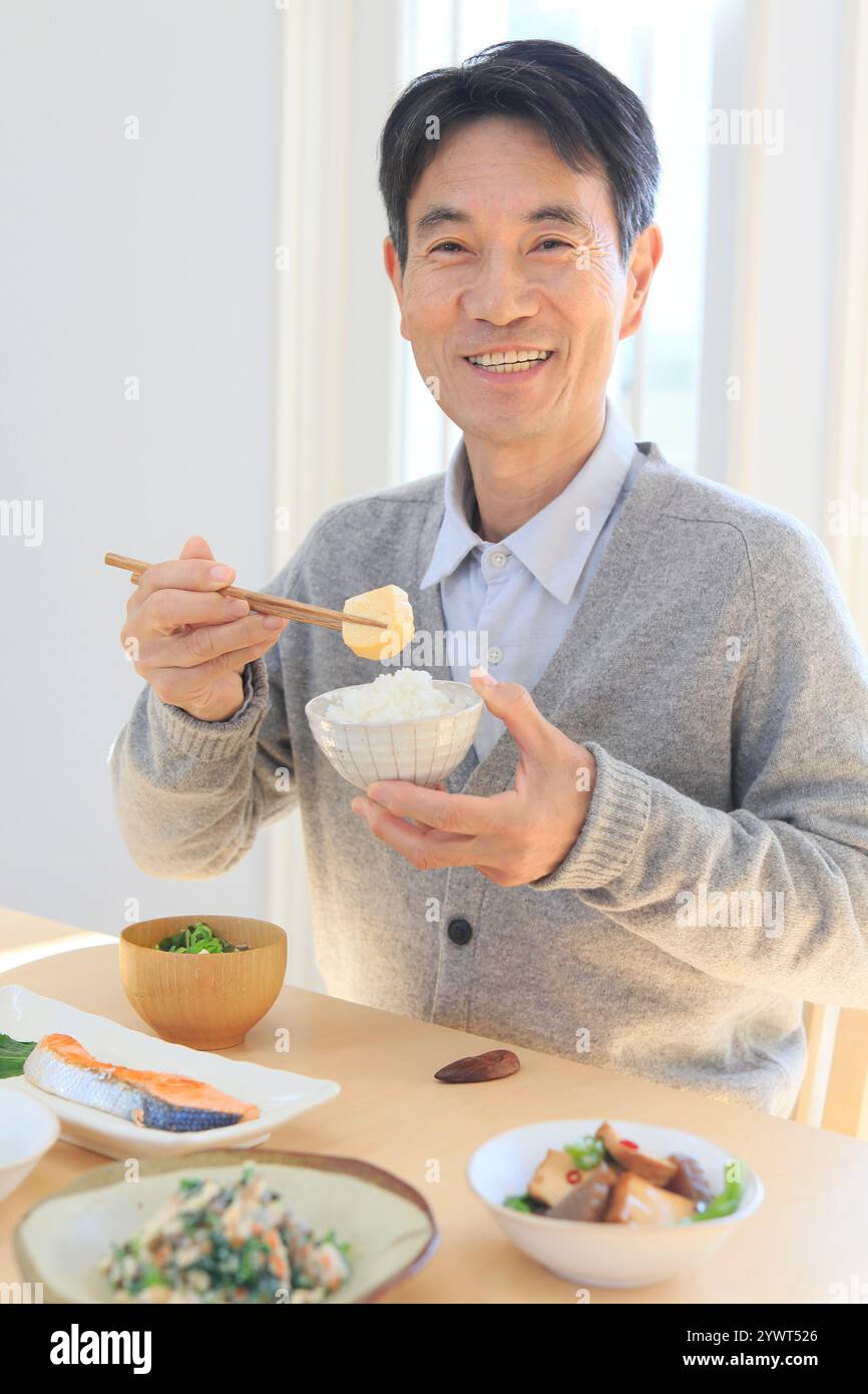 Middle-aged man eating breakfast Stock Photo - Alamy