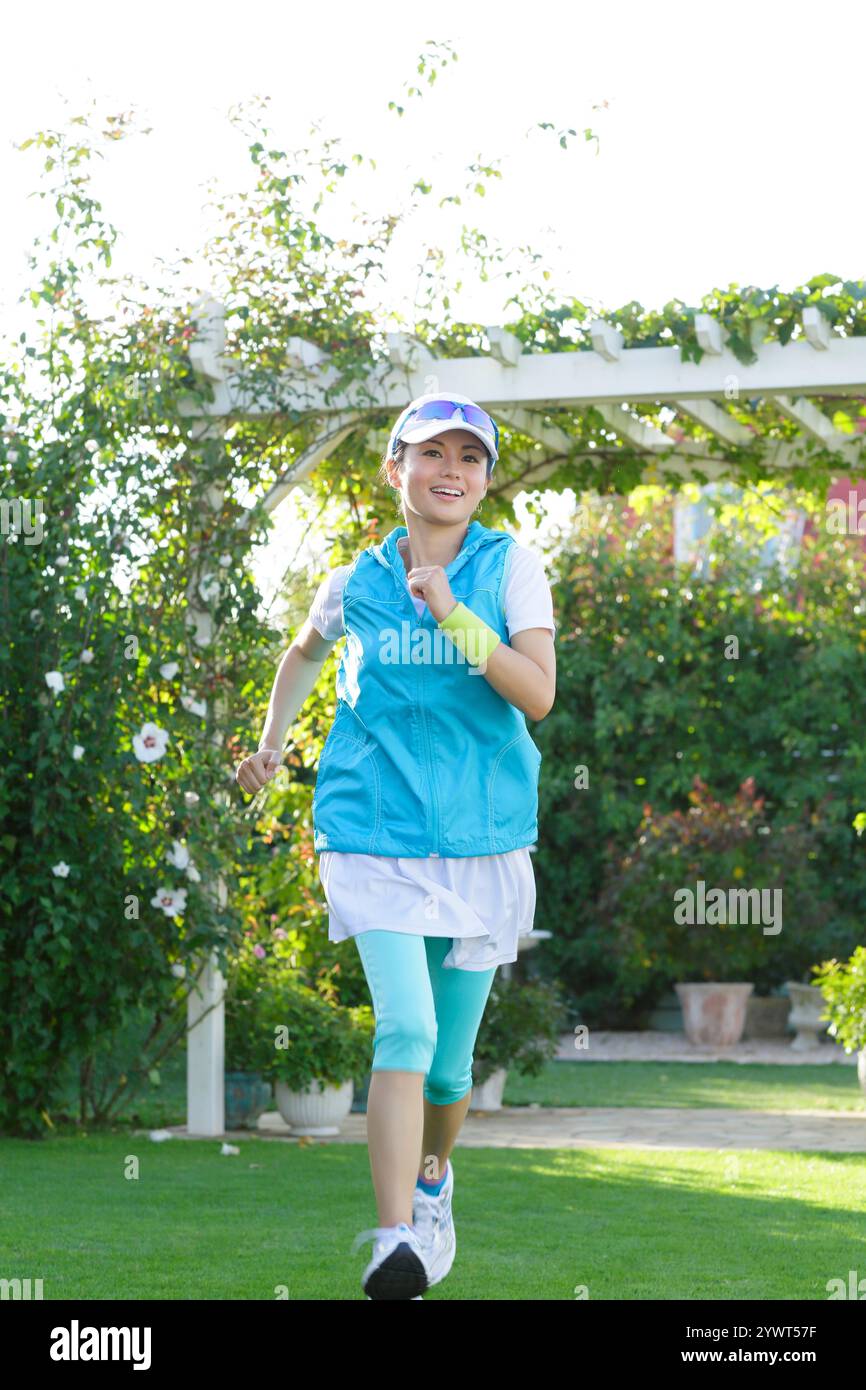 Japanese woman running in park Stock Photo - Alamy