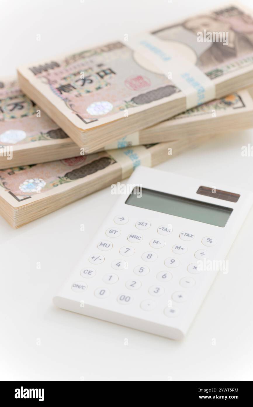 A stack of notes and a calculator Stock Photo - Alamy