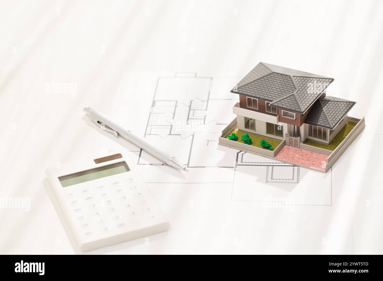 Miniature house and floor plan, calculator Stock Photo - Alamy