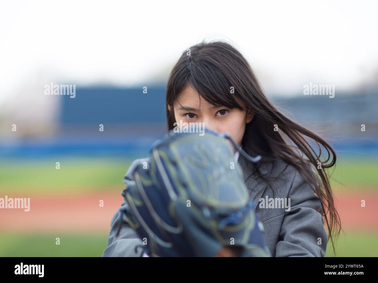 Female student preparing to throw a baseball Stock Photo - Alamy