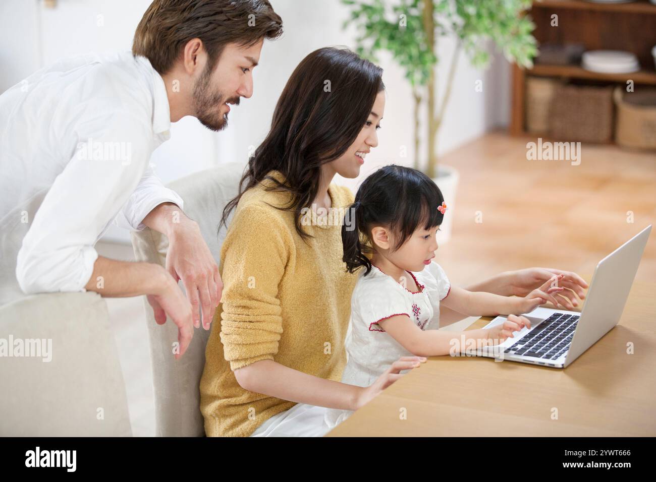 Parent and child sitting on chair looking at computer Stock Photo - Alamy