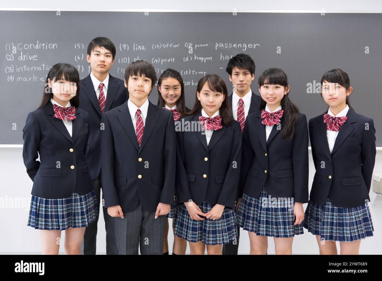 Portrait of students standing in front of blackboard Stock Photo - Alamy