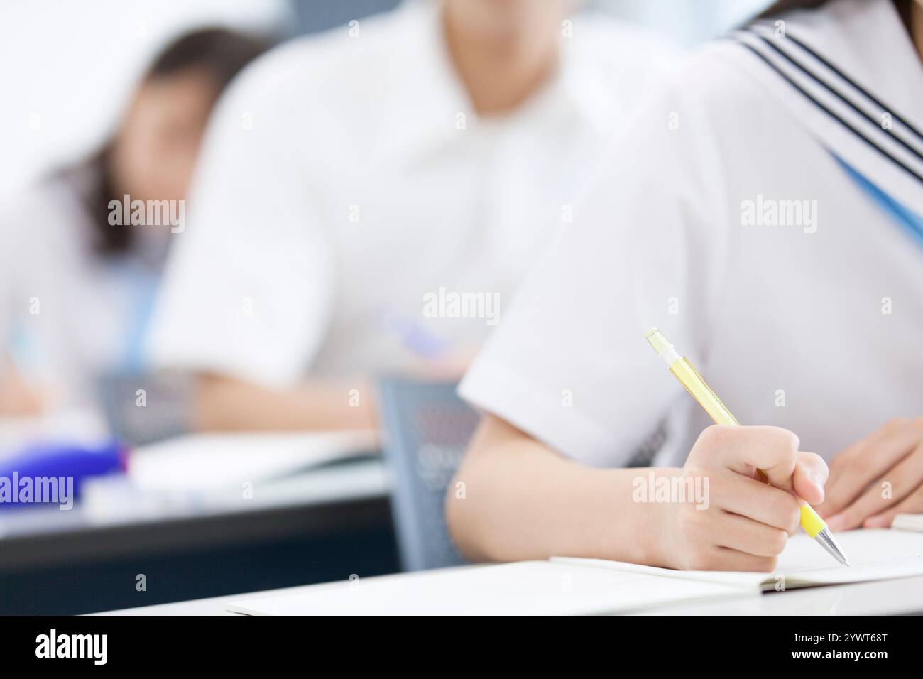 Female student writing letters in notebook in hand Stock Photo - Alamy