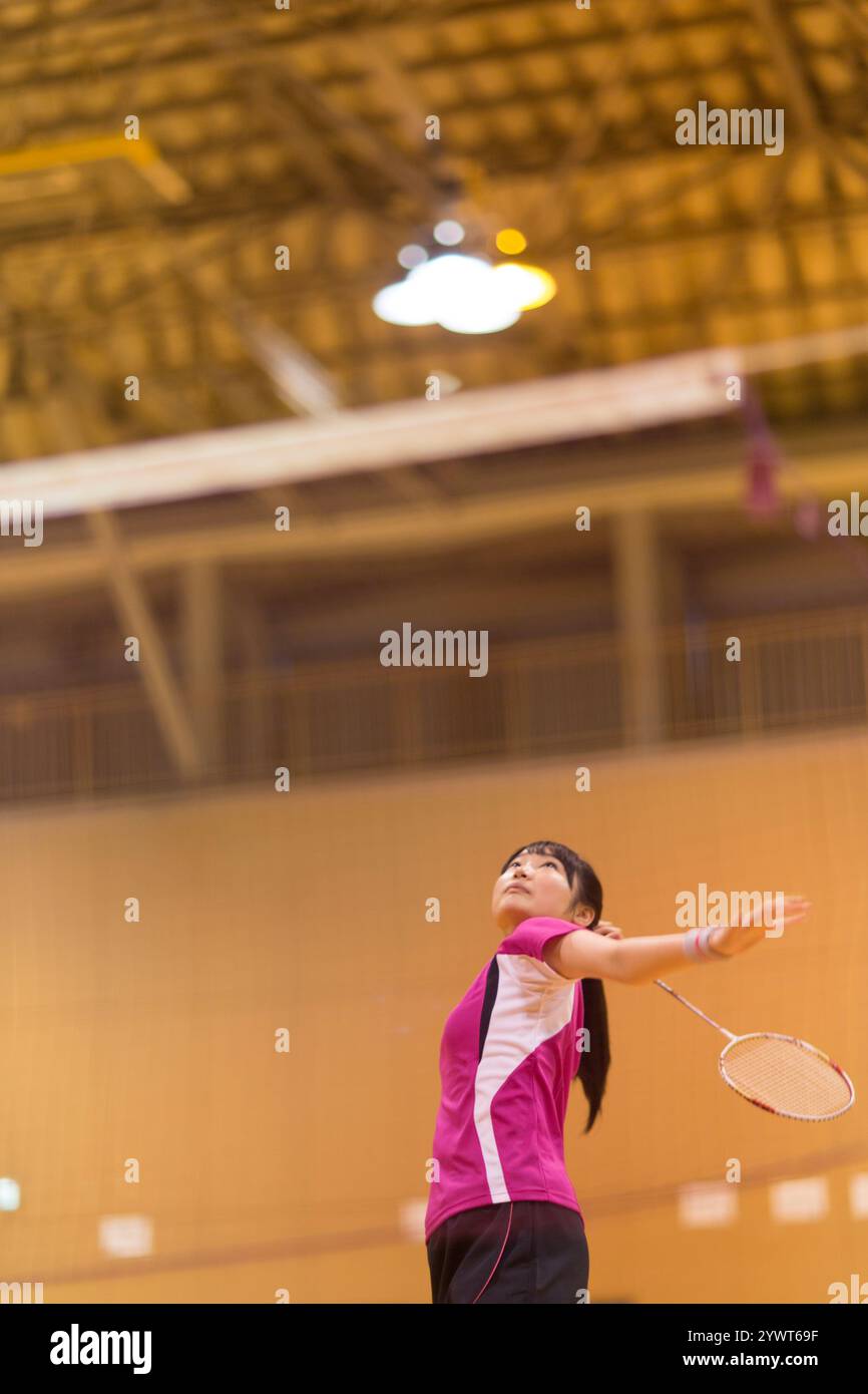 Female student playing badminton Stock Photo - Alamy