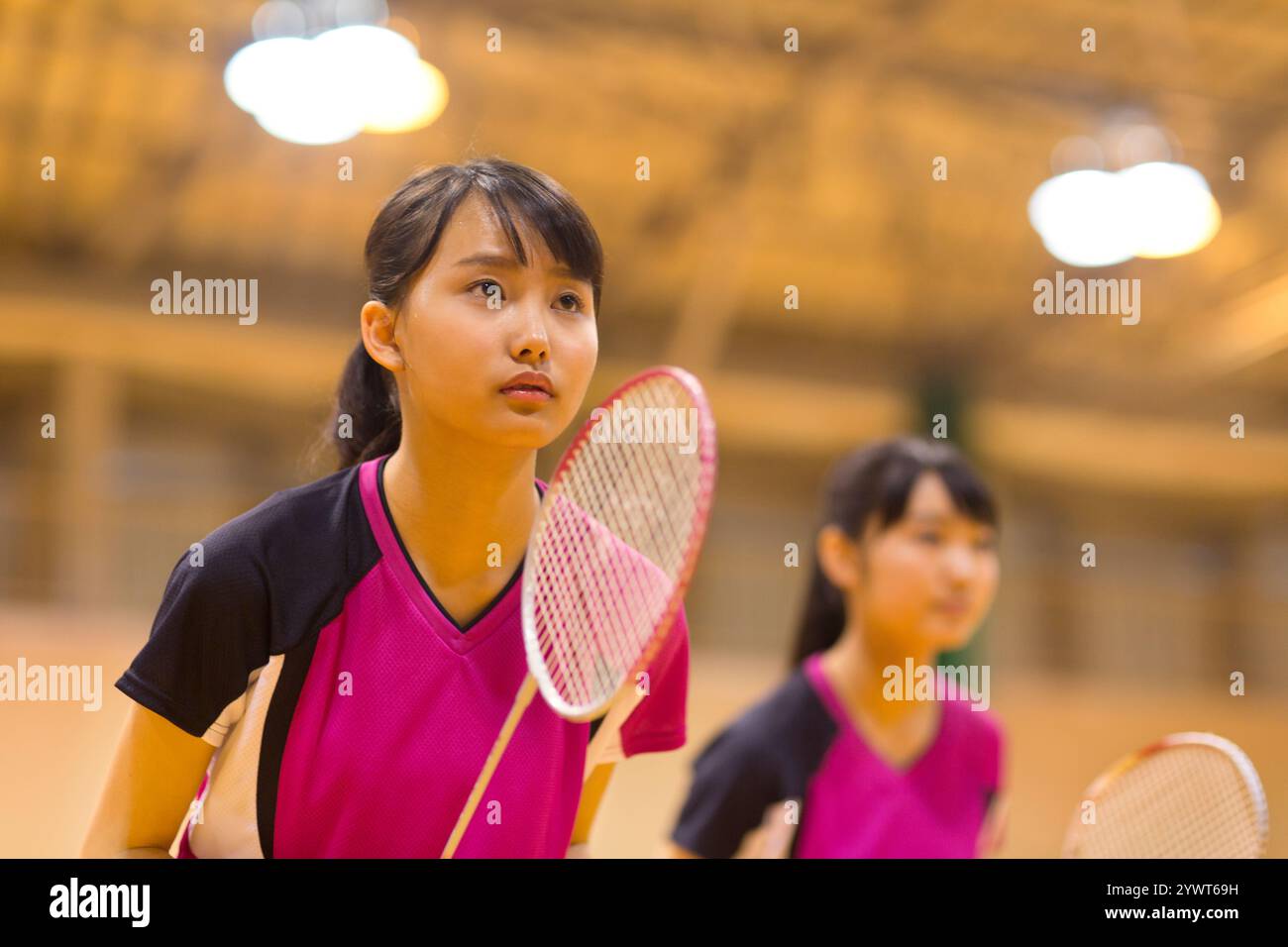 Female student playing badminton Stock Photo - Alamy