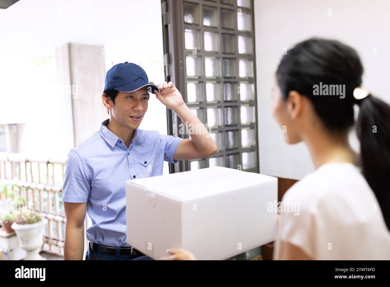 Young japanese delivery man box hi-res stock photography and images - Alamy